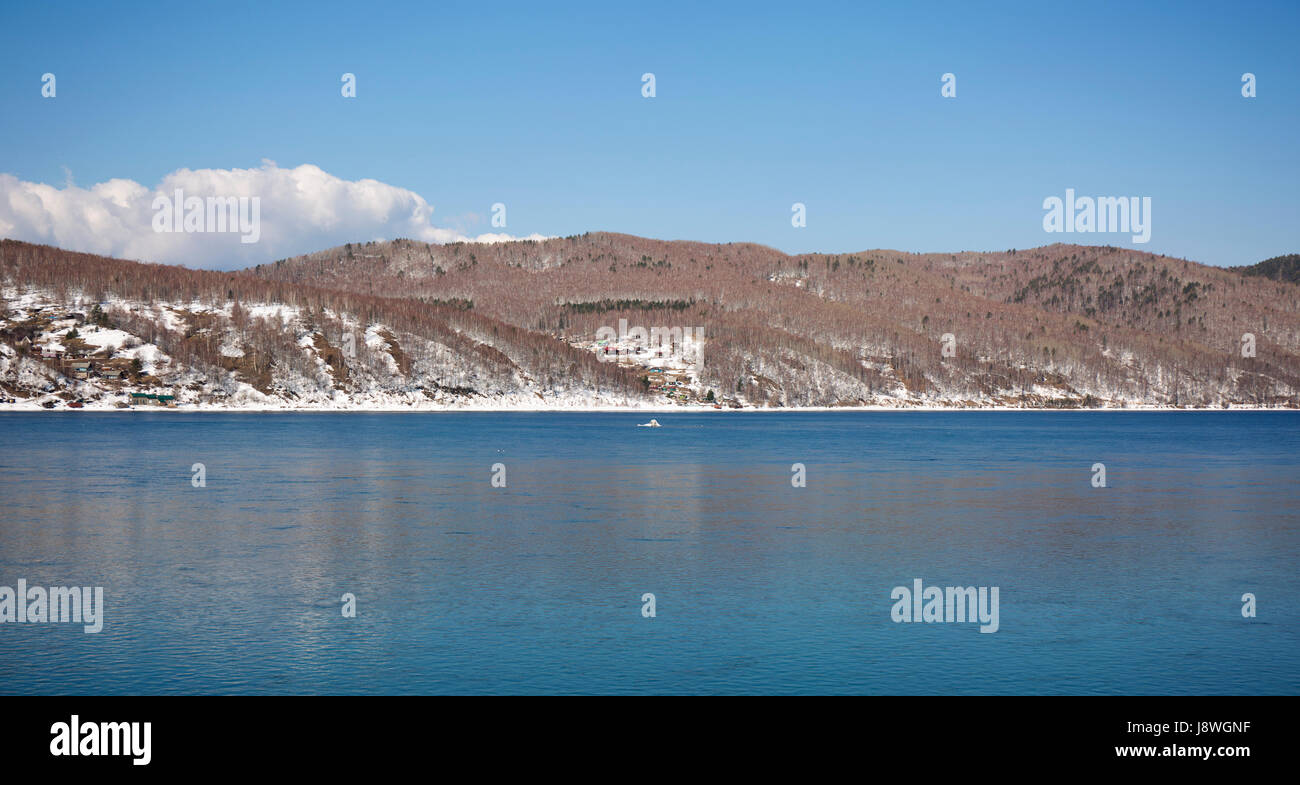 Baikal lake spring landscape view. Snow-covered shore of the lake ...