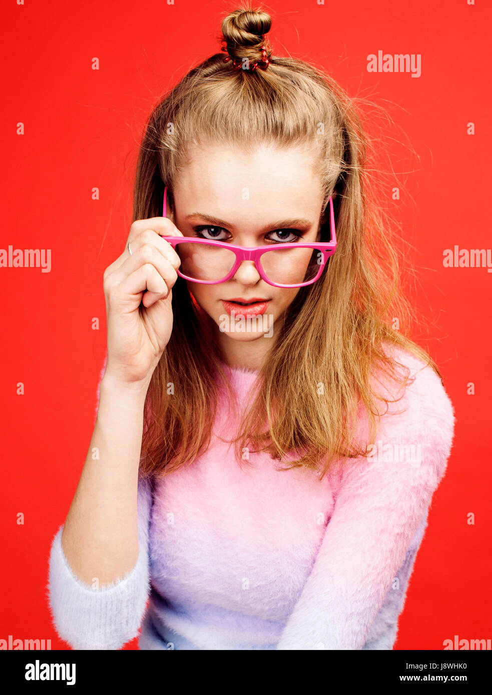 young pretty emitonal posing teenage girl on bright red background ...