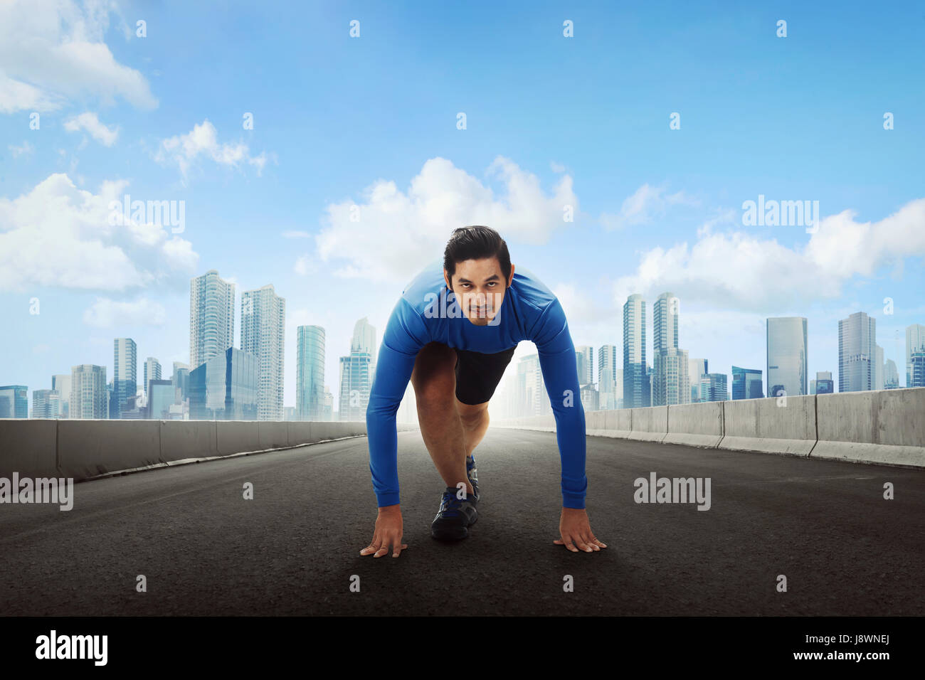 Sporty asian man runner getting ready for running on road with ...