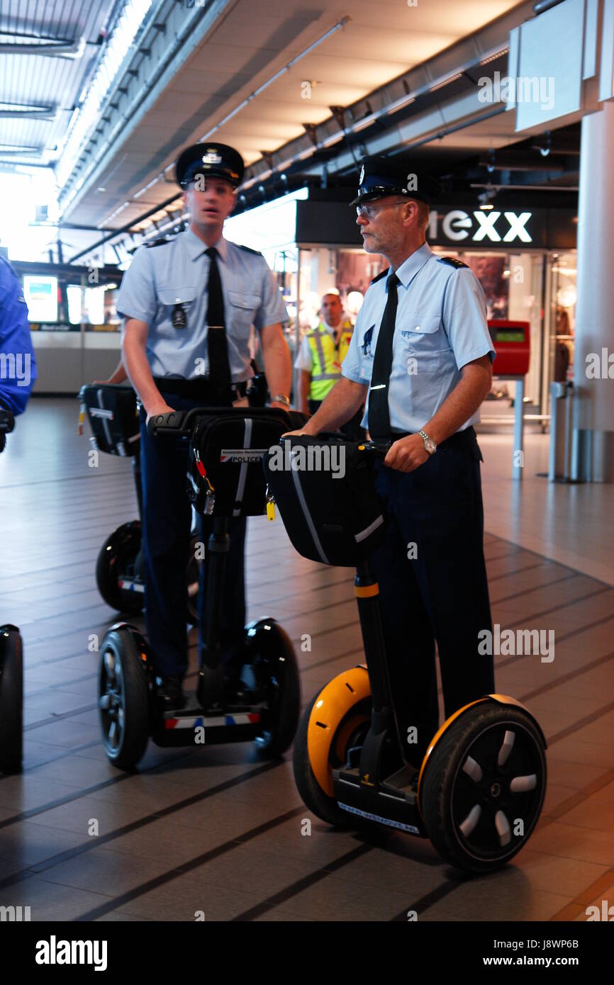 Two holland policemen on Segways, Amsterdam Airport Stock Photo - Alamy