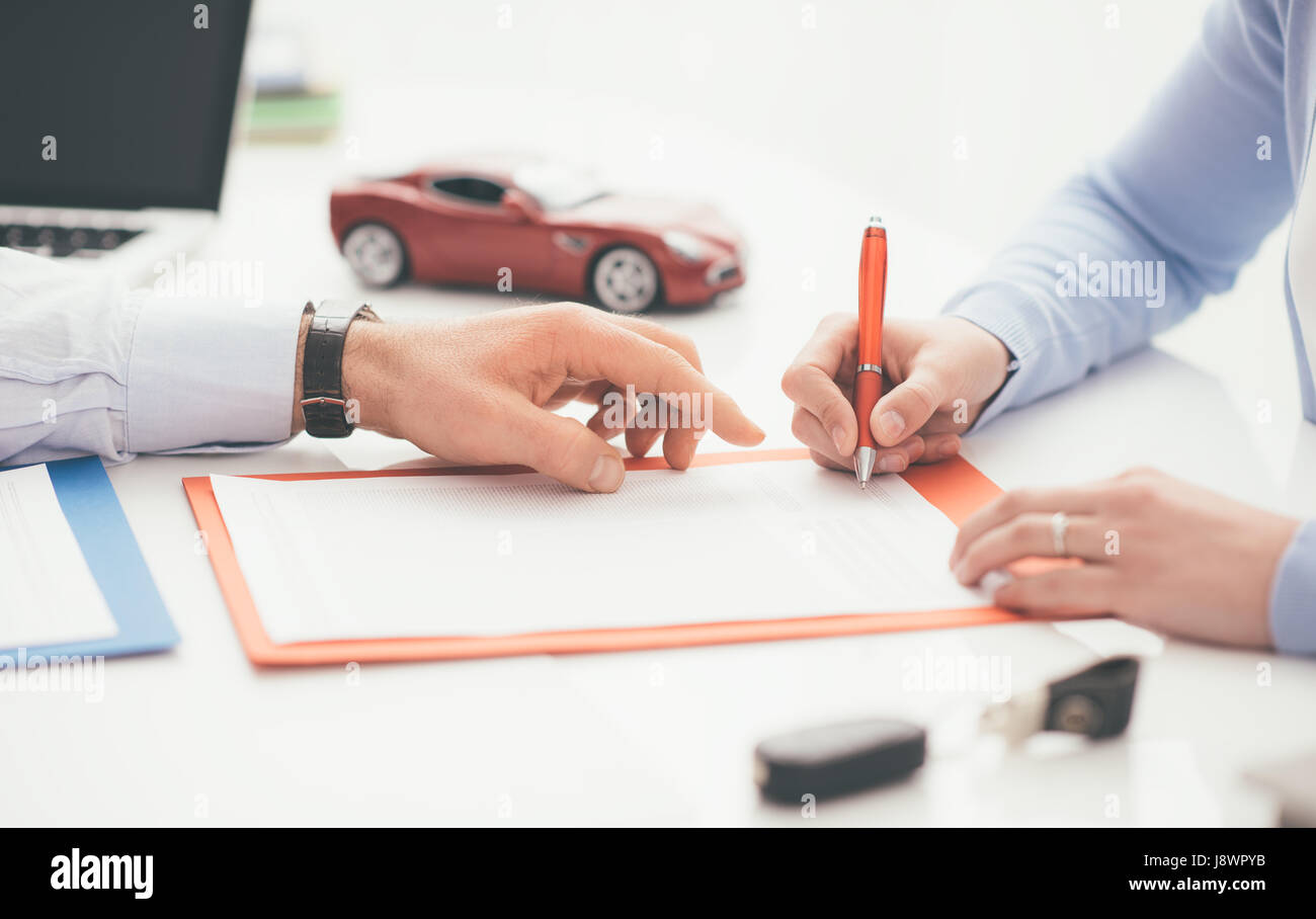 Woman signing form car hi-res stock photography and images - Alamy