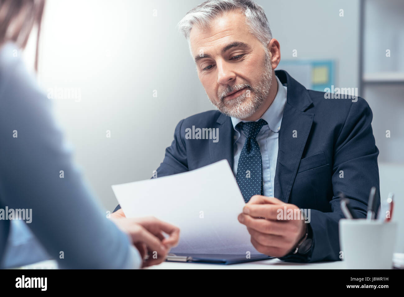 Young woman having a job interview with a corporate manager in his ...