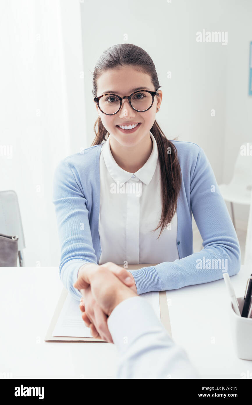 Young smart woman having a successful job interview, the examiner is ...