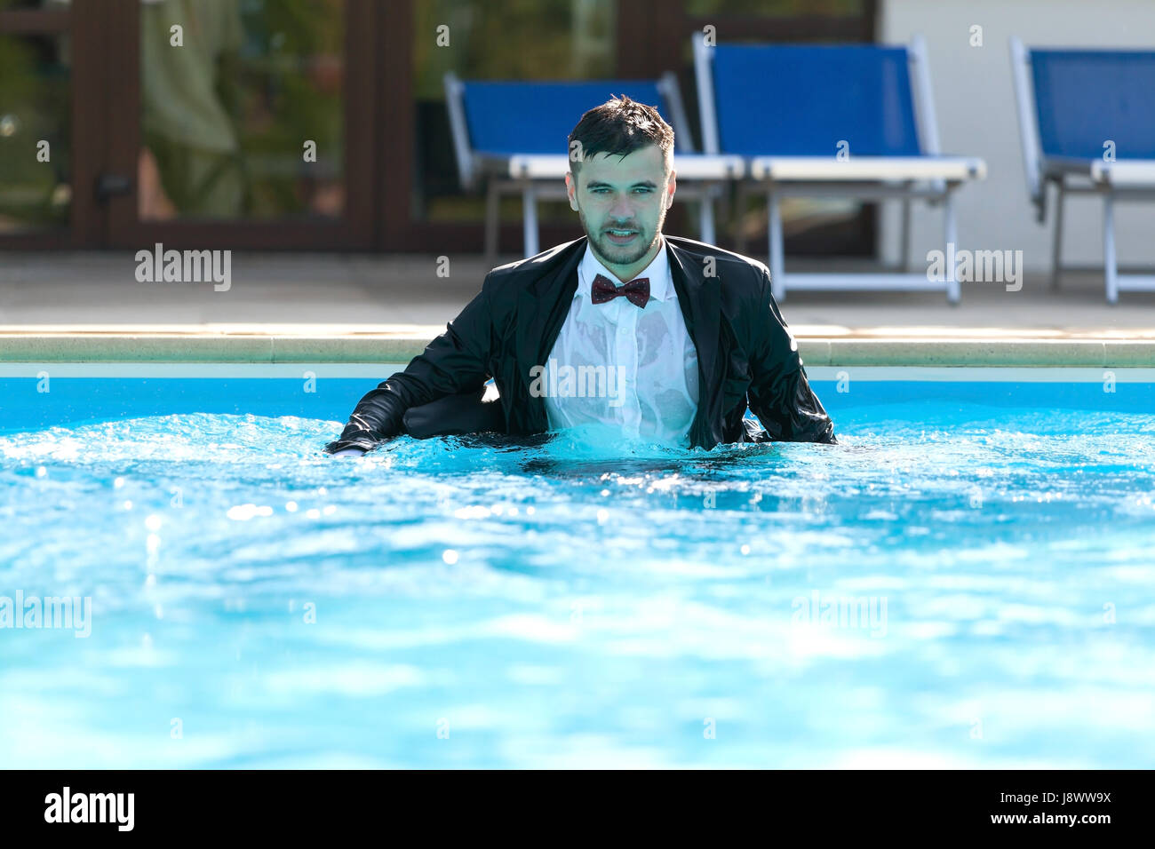 Businessman enjoying the relaxing time in the pool with suit on Stock ...