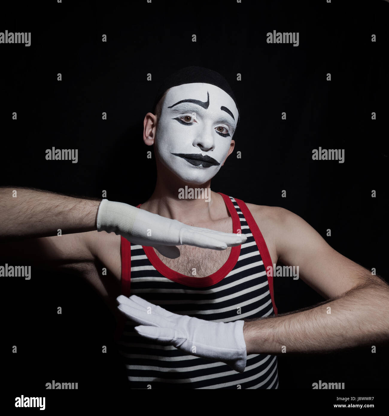 Portrait of gesticulating mime on black background Stock Photo - Alamy