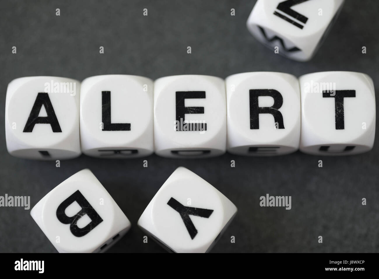 word alert on white toy cubes Stock Photo - Alamy
