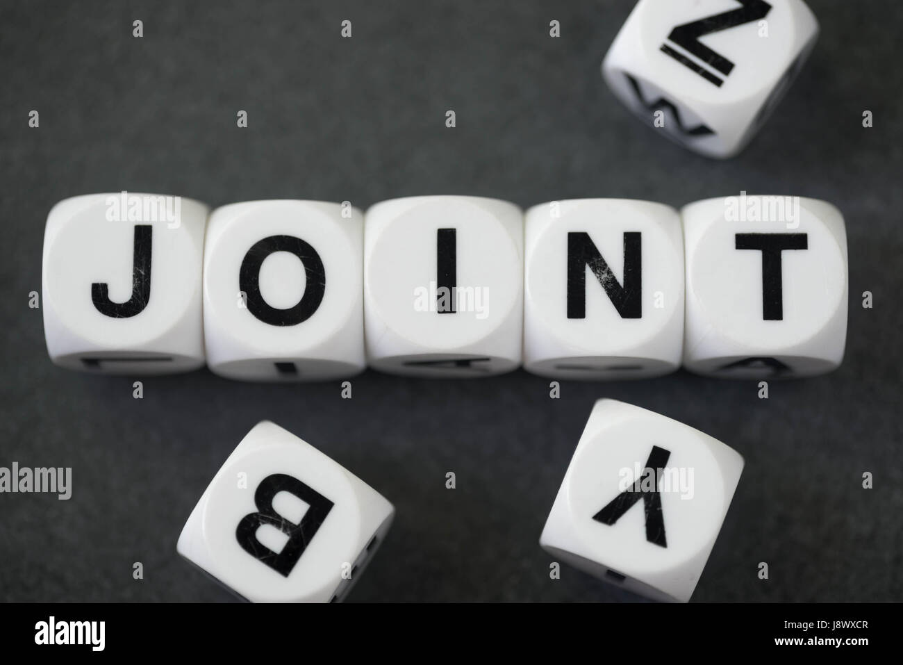 word joint on white toy cubes Stock Photo - Alamy