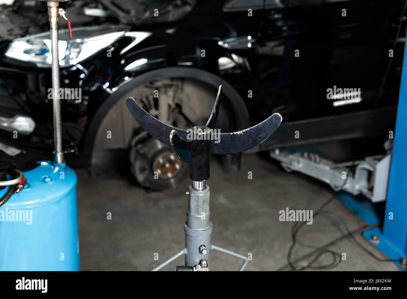 hydraulic Jack for the engine, and large auto parts. The car on the ...