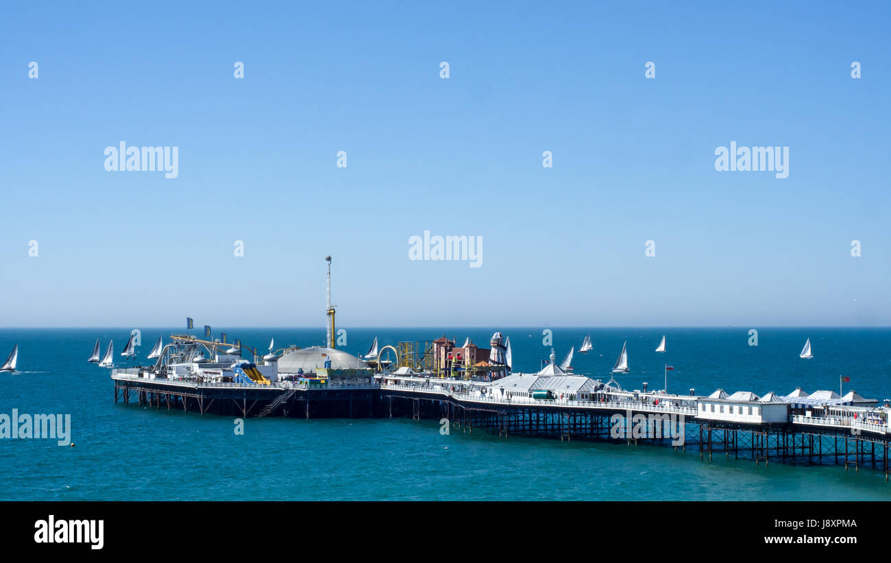 Sailing boats in a regatta around the Victorian Brighton Pier, Southern ...