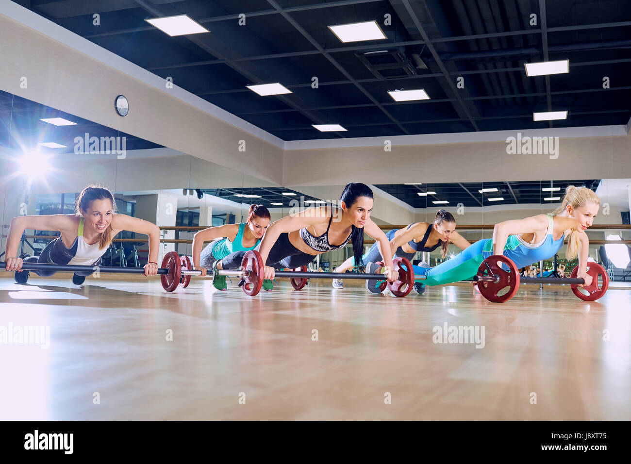 Girls do push ups from floor in the gym. Group training Stock Photo - Alamy