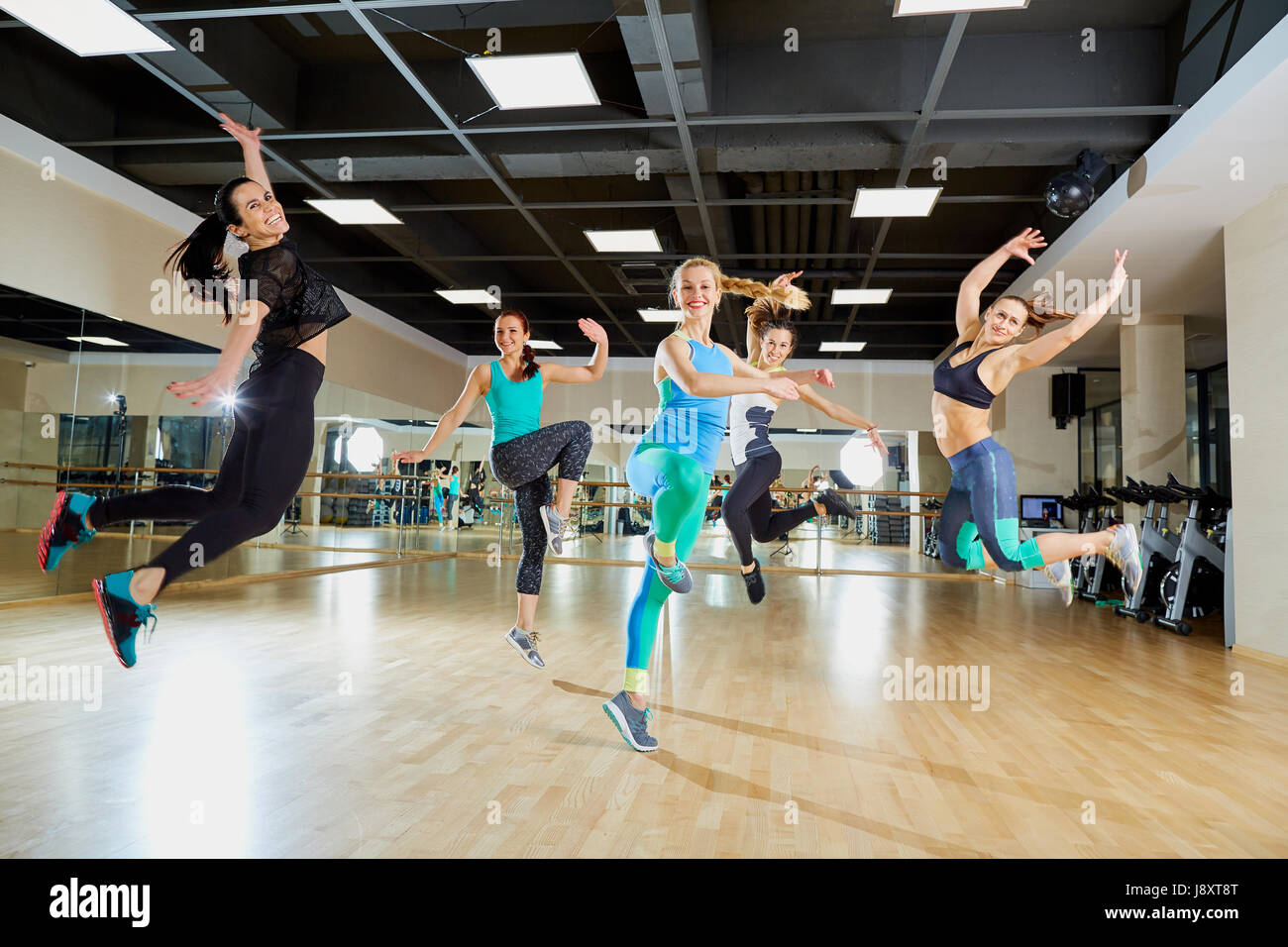A group of girls jump with smiles in the gym Stock Photo - Alamy