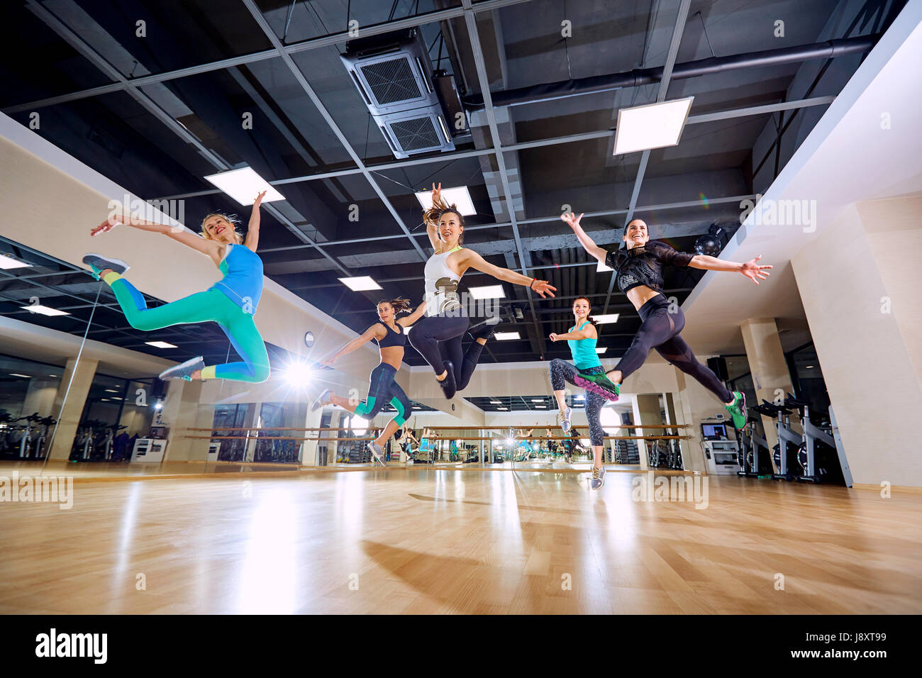 A group of girls jump with smiles in the gym Stock Photo - Alamy