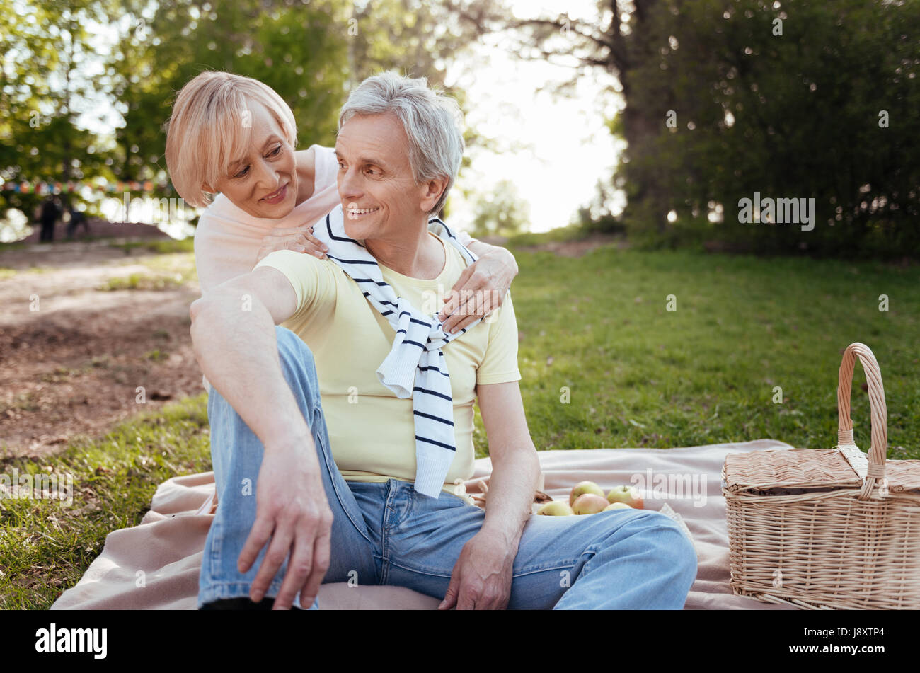 Optimistic aging couple sharing positivity at the picnic Stock Photo ...
