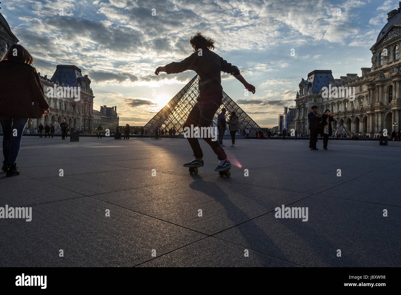 Roller skating practice at Louvre Pyramid at sunset Stock Photo - Alamy