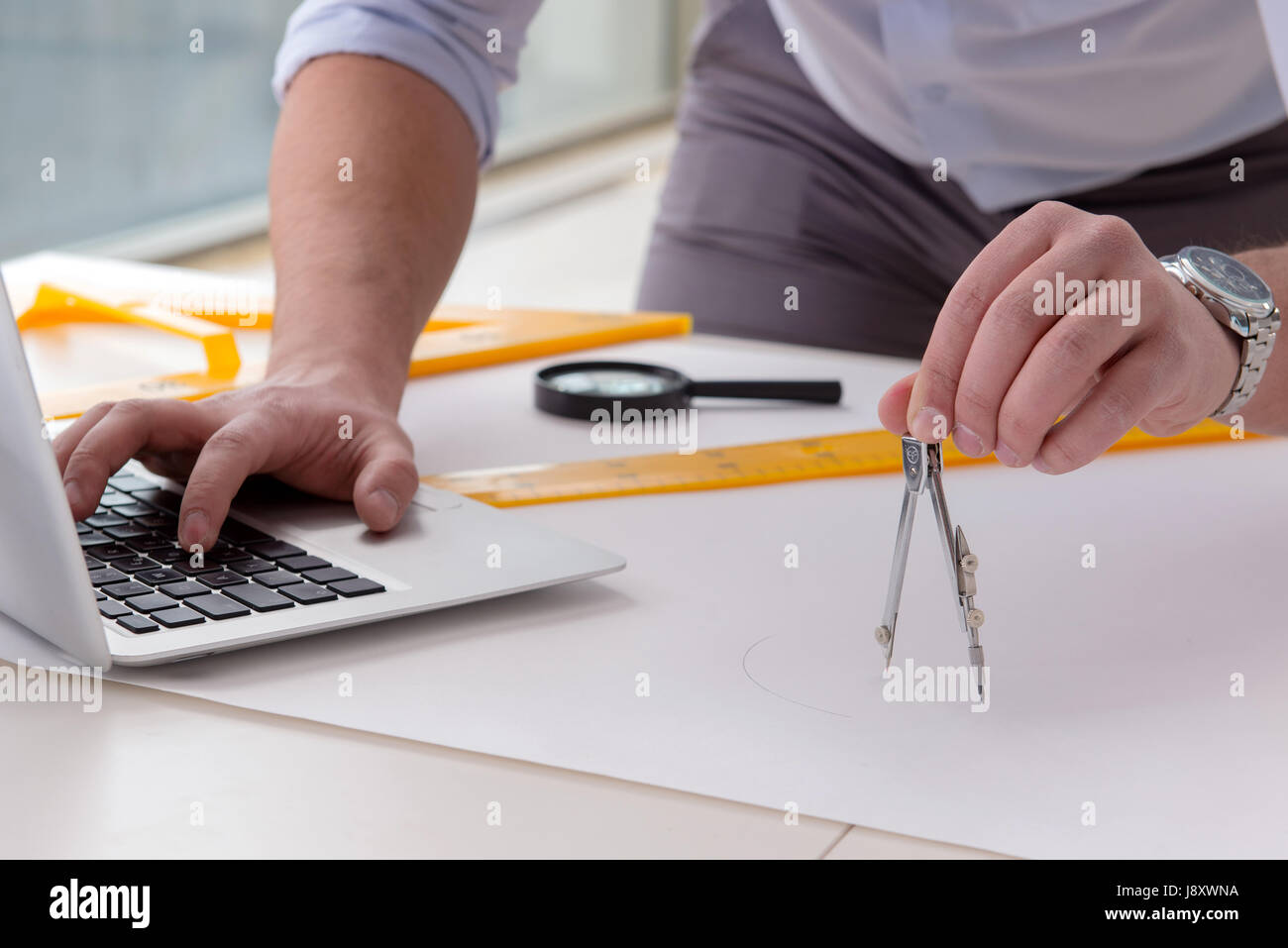 Male engineer working on drawings and blueprints Stock Photo - Alamy