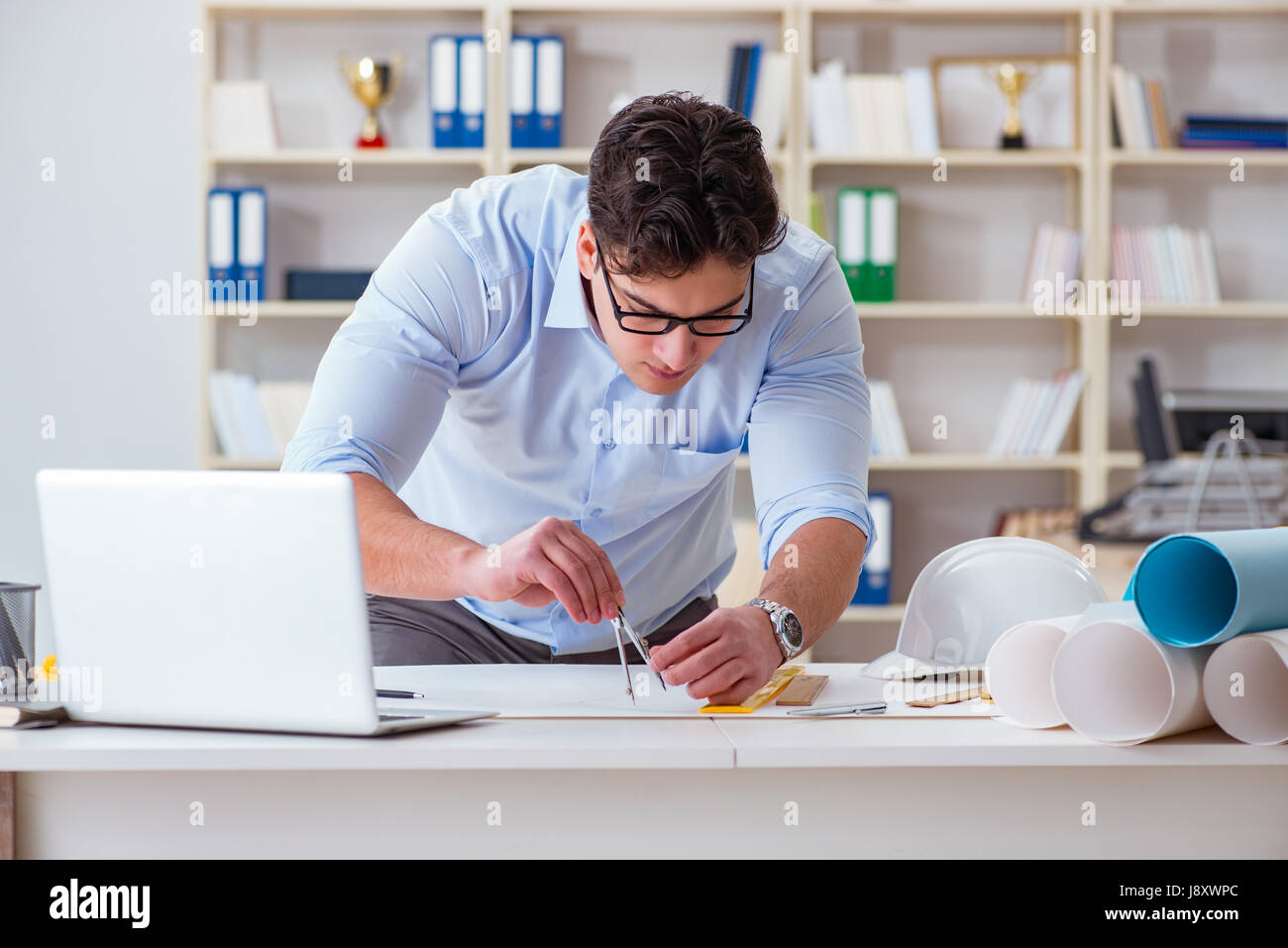 Male engineer working on drawings and blueprints Stock Photo - Alamy
