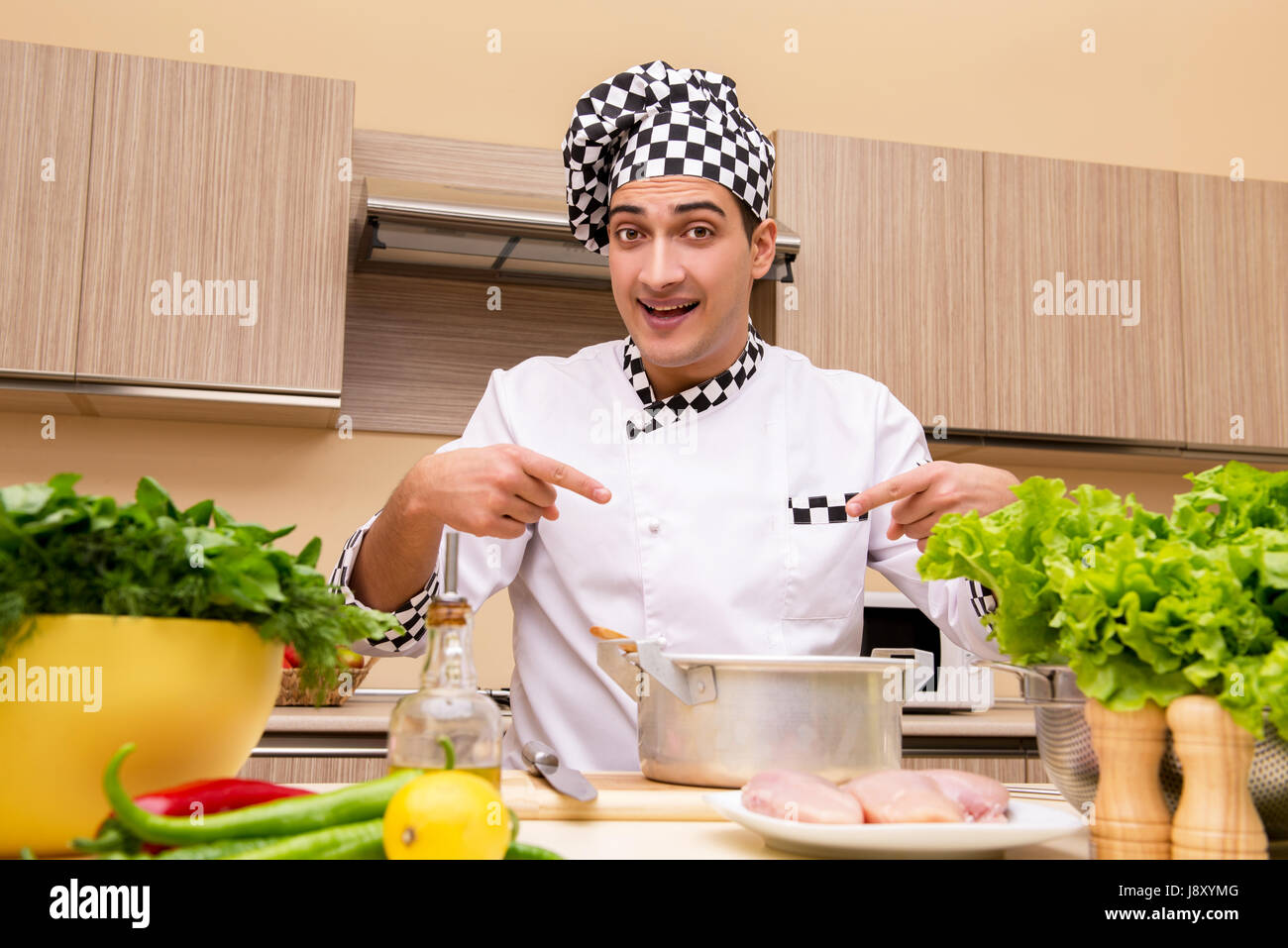 Young chef working in the kitchen Stock Photo - Alamy