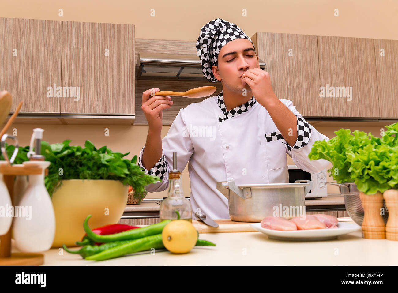 Young chef working in the kitchen Stock Photo - Alamy