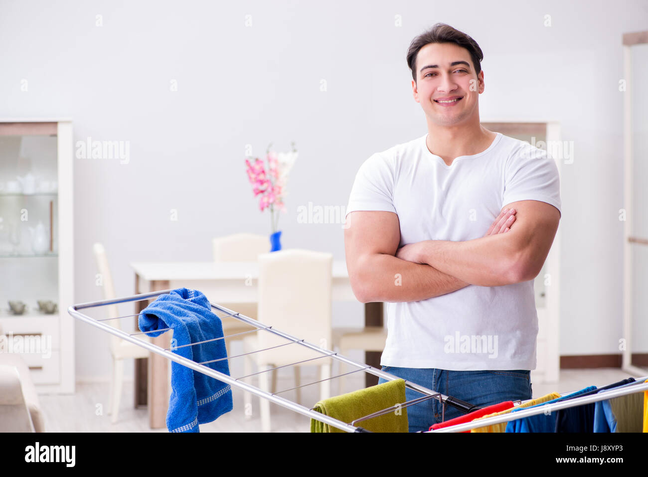 Man doing laundry at home Stock Photo - Alamy