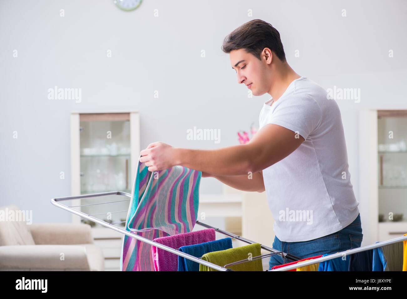 Man doing laundry at home Stock Photo - Alamy