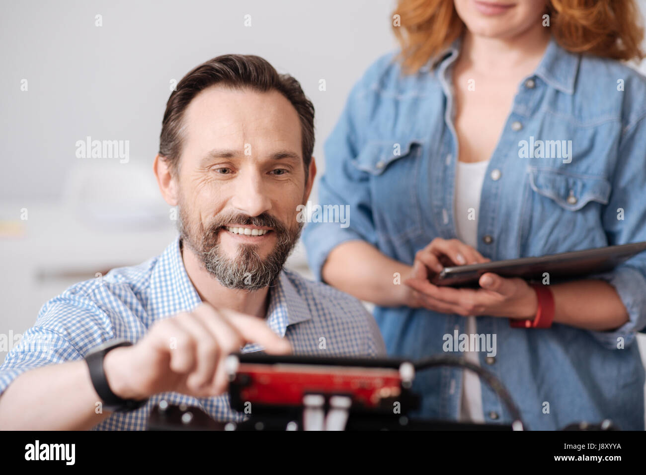 Cheerful delighted man pressing a button Stock Photo - Alamy