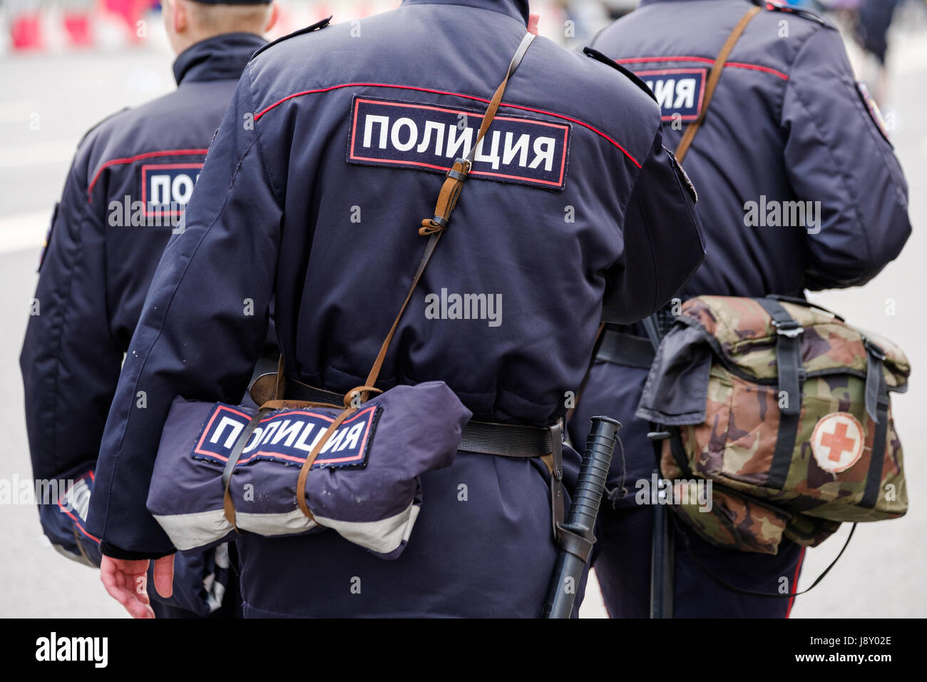 Policemen in uniform, rear view Stock Photo - Alamy