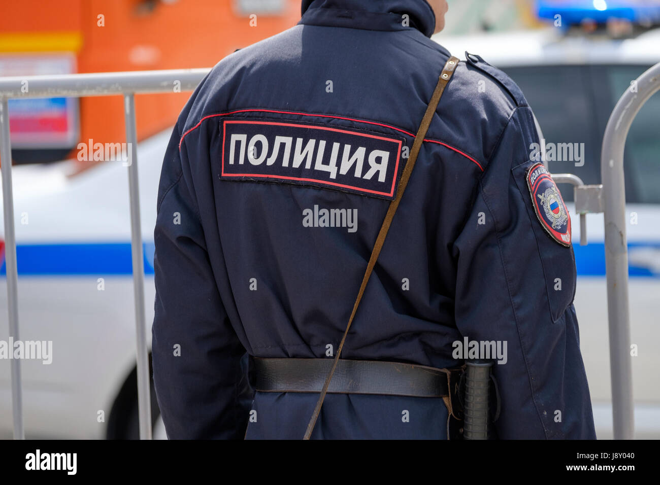 Policeman in uniform, rear view Stock Photo - Alamy
