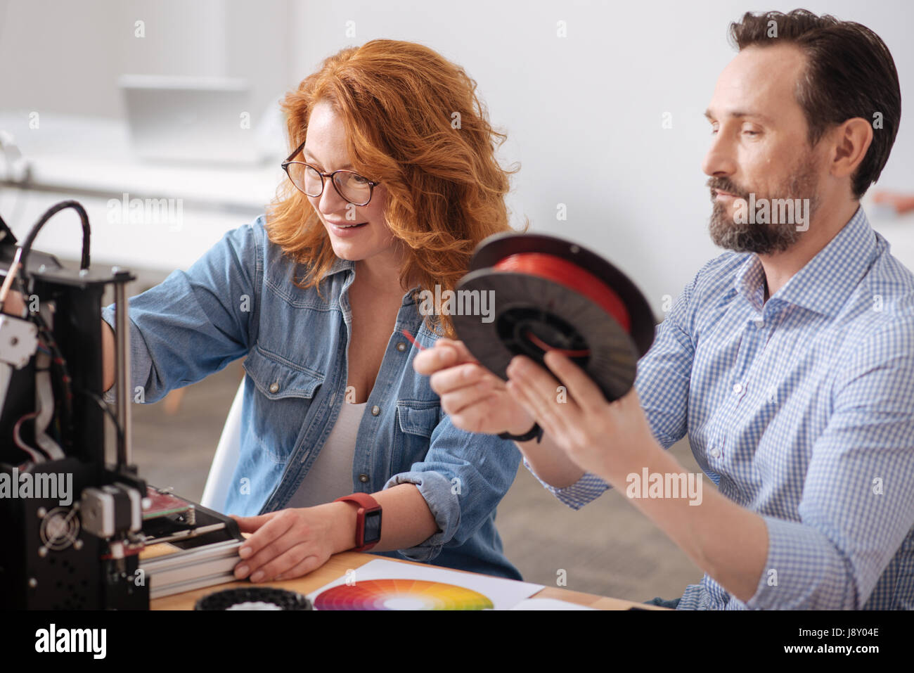 Positive professional designers working in team Stock Photo - Alamy