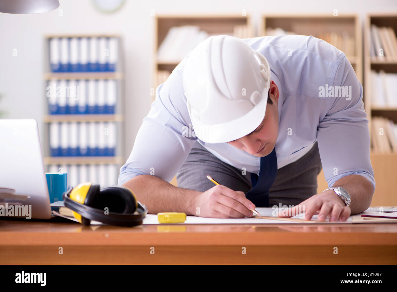 Engineer supervisor working on drawings in the office Stock Photo - Alamy