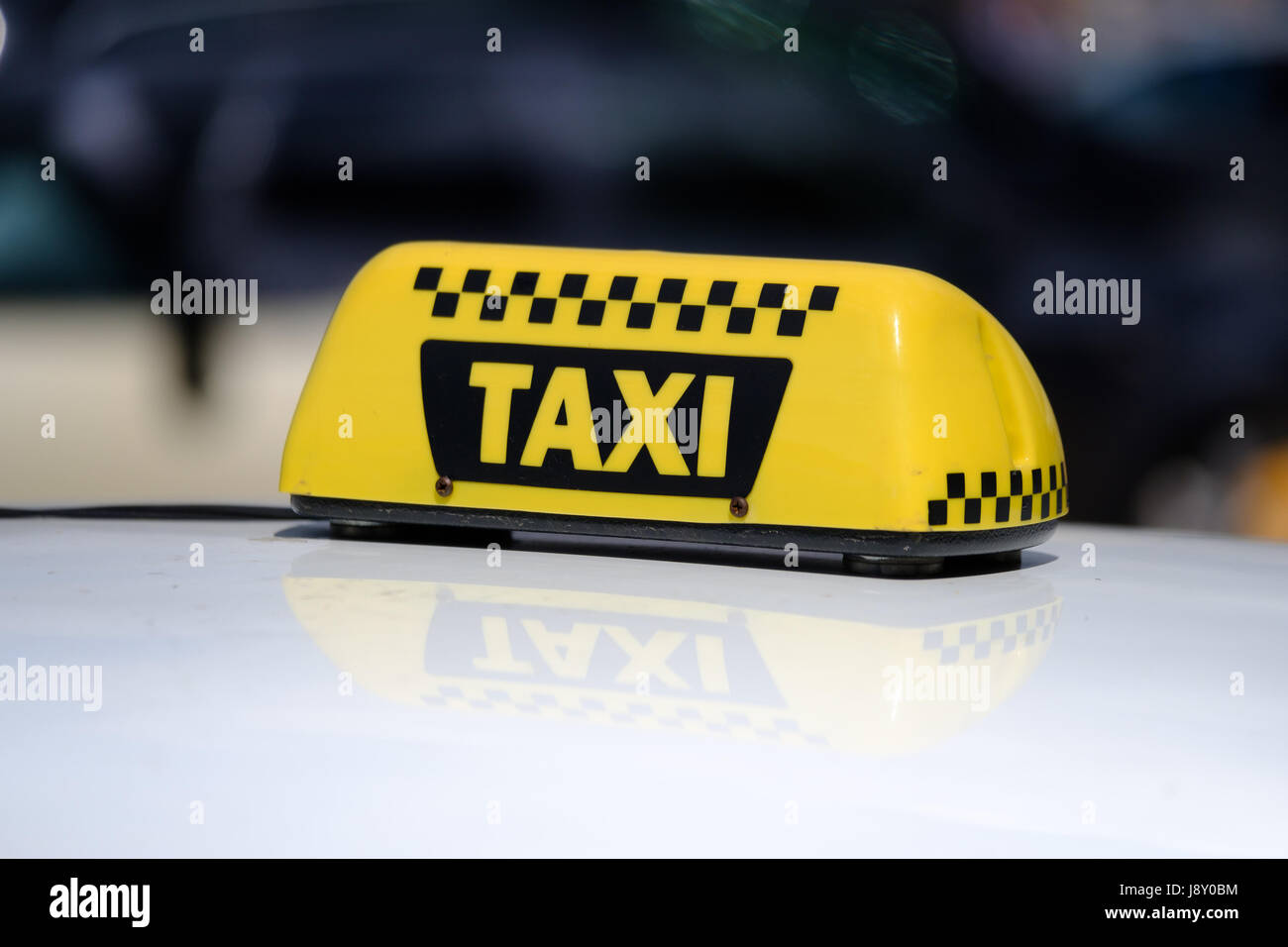 Taxi sign on the roof of the car Stock Photo - Alamy