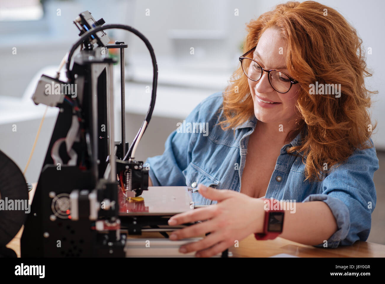 Cheerful nice designer using a 3d printer Stock Photo - Alamy