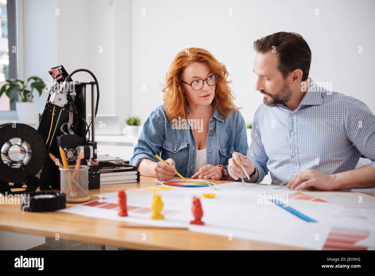 Nice serious colleagues working together Stock Photo - Alamy