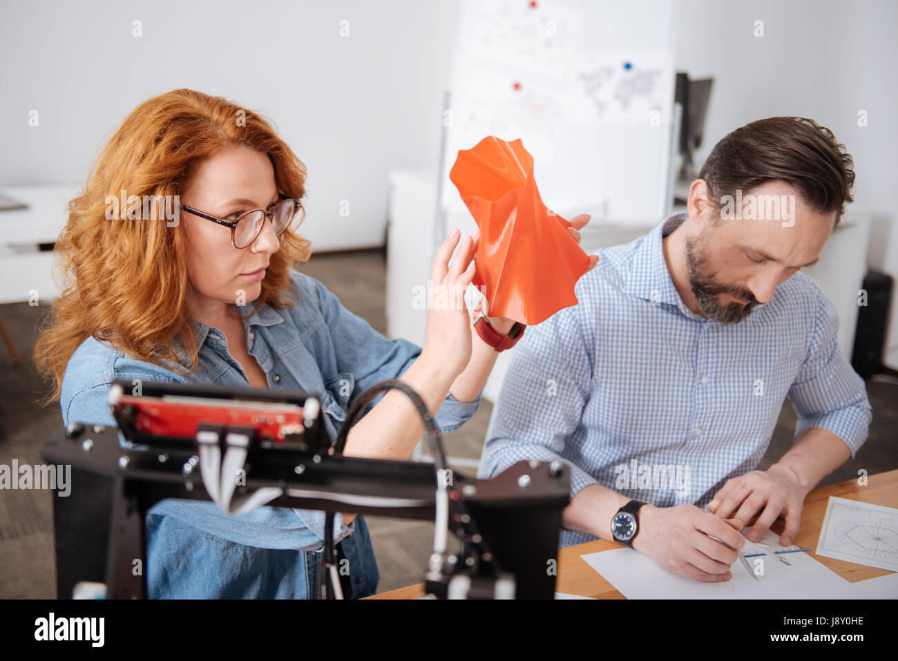 Serious beautiful woman holding a 3d printed object Stock Photo - Alamy