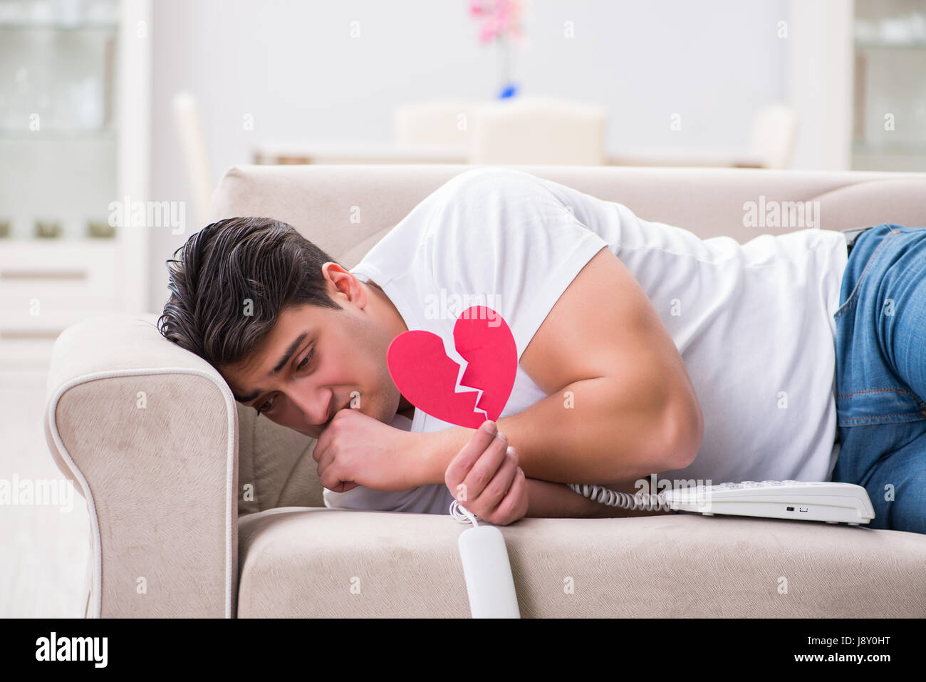 Young man in sad saint valentine concept Stock Photo - Alamy