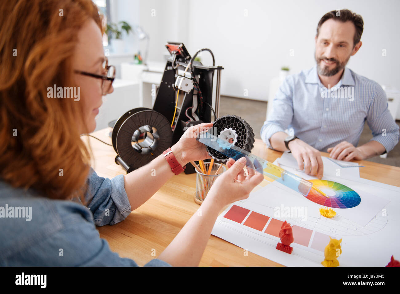 Nice professional designer holding a ruler Stock Photo - Alamy