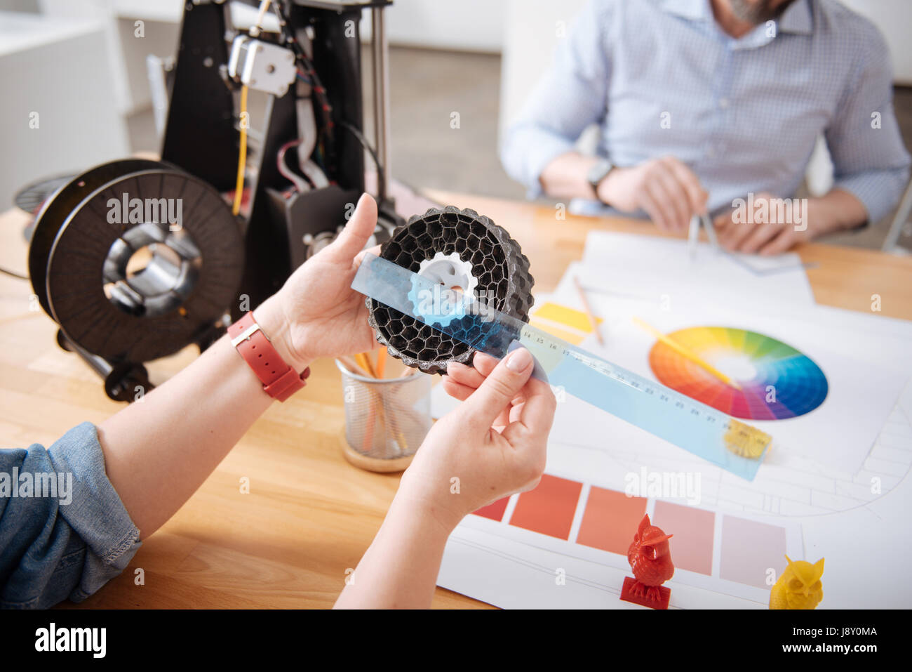 Ruler being in hands of a female designer Stock Photo - Alamy