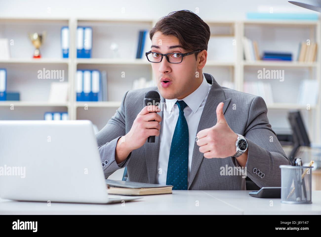 Businessman singing in the office Stock Photo - Alamy