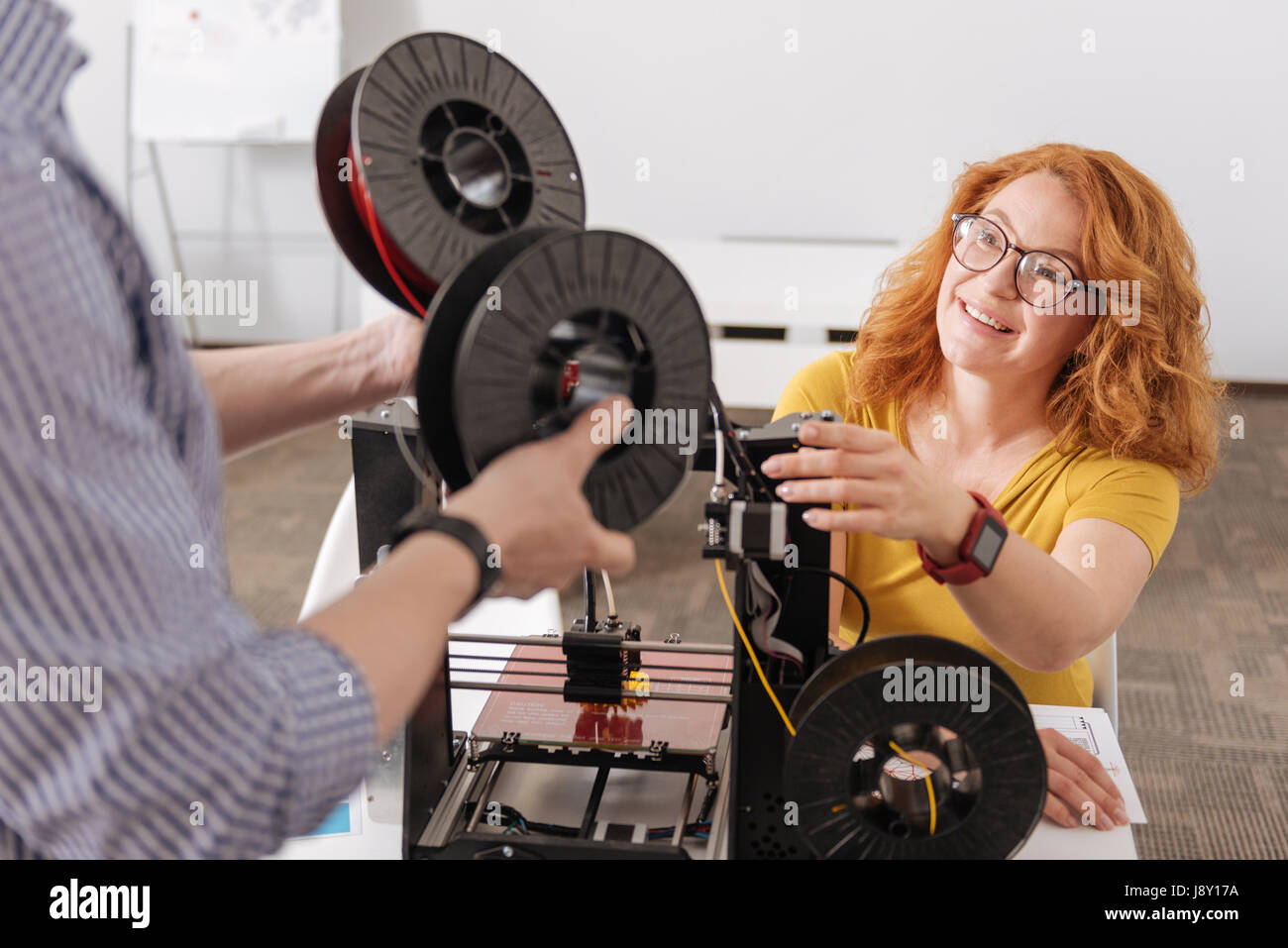 Delighted positive woman taking filament coils Stock Photo - Alamy