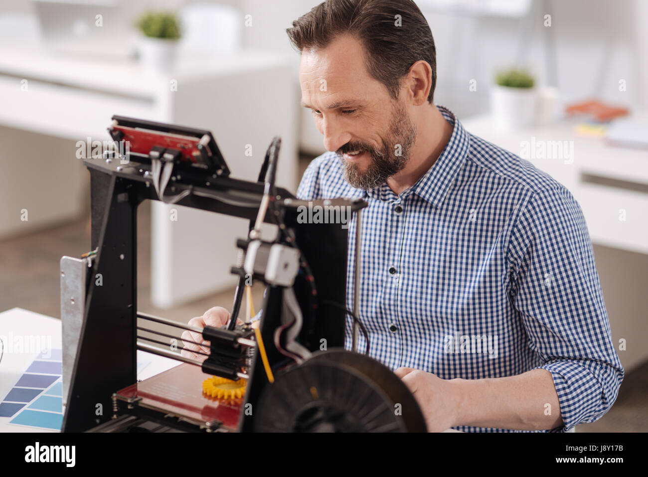 Cheerful positive delighted printing a 3d object Stock Photo - Alamy