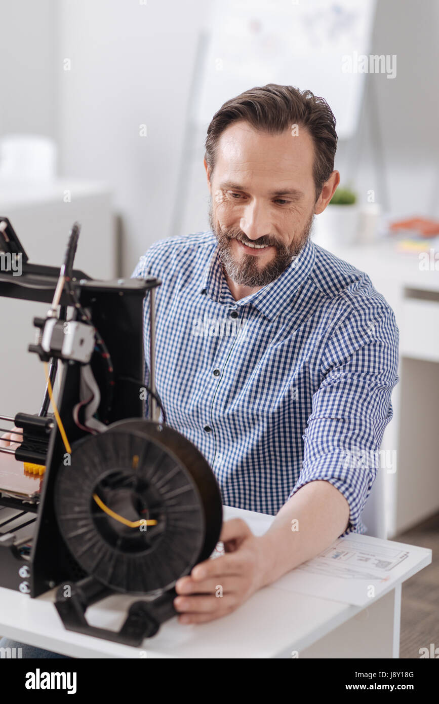 Delighted joyful man working in his office Stock Photo - Alamy