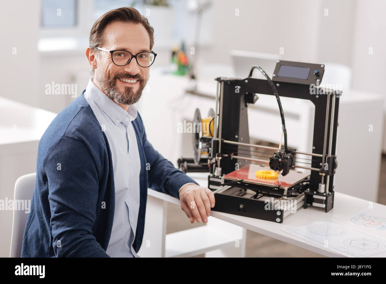 Smart cheerful designer smiling Stock Photo - Alamy