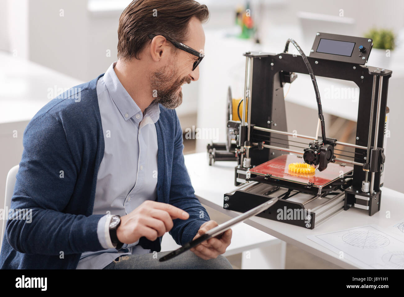 Handsome positive man designing a new object Stock Photo - Alamy