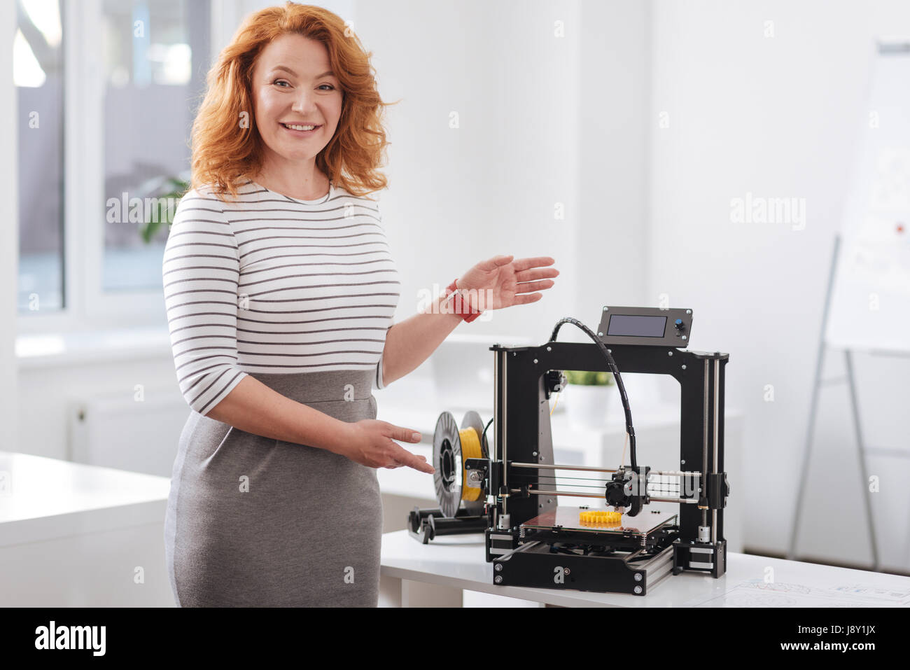 Good looking attractive woman showing you a 3d printer Stock Photo - Alamy