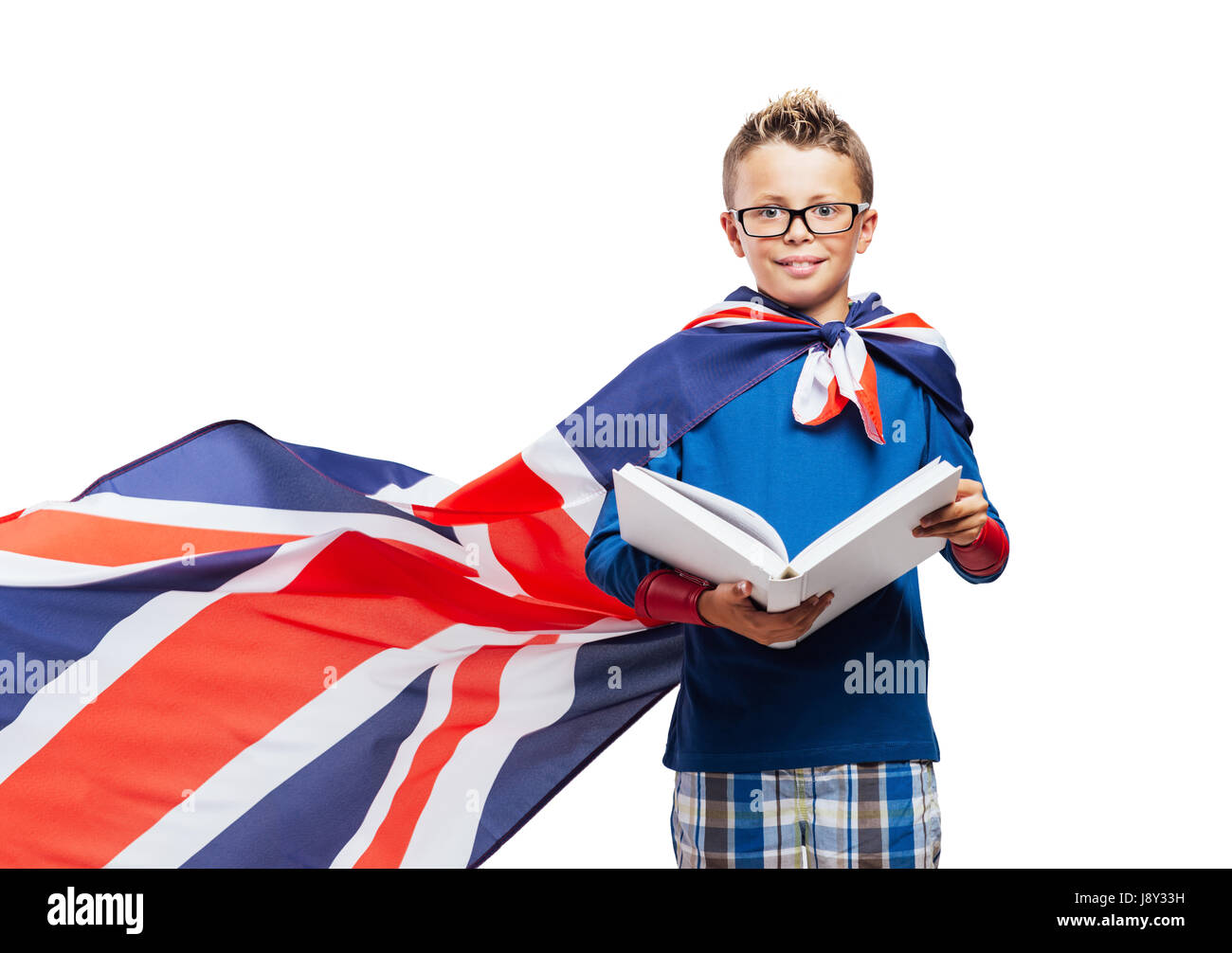 Cute superhero boy reading a book, he is wearing a British flag as a ...