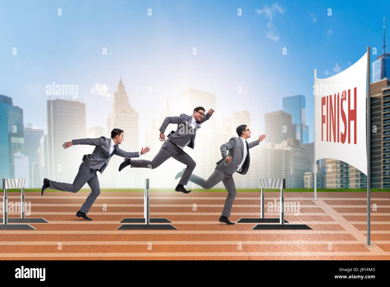 Businessman jumping over barriers in business concept Stock Photo - Alamy