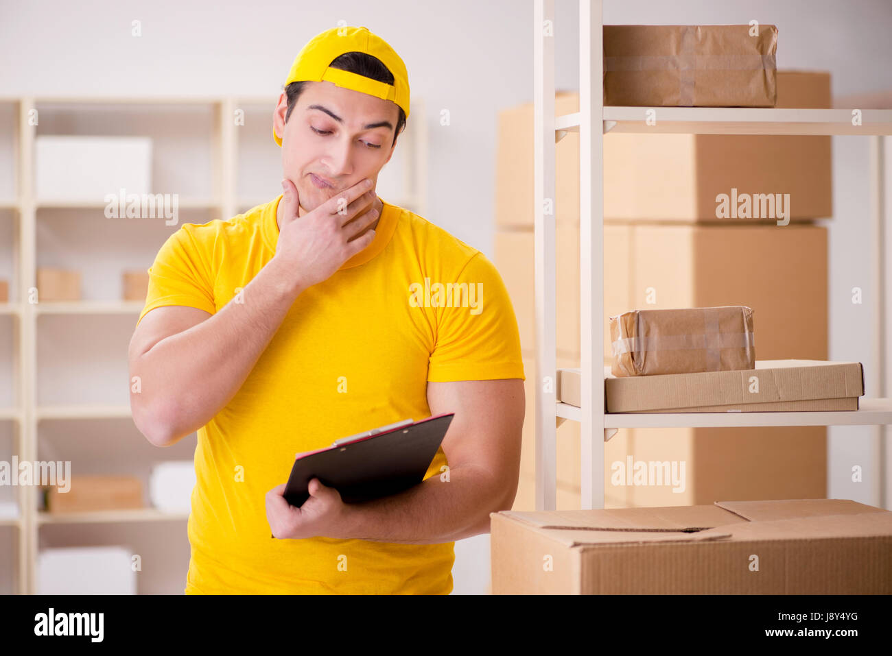 Man working in postal parcel delivery service office Stock Photo - Alamy