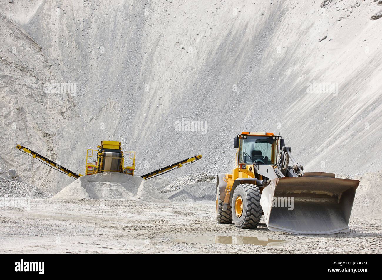 Quarry aggregate with heavy duty machinery. Construction industry ...
