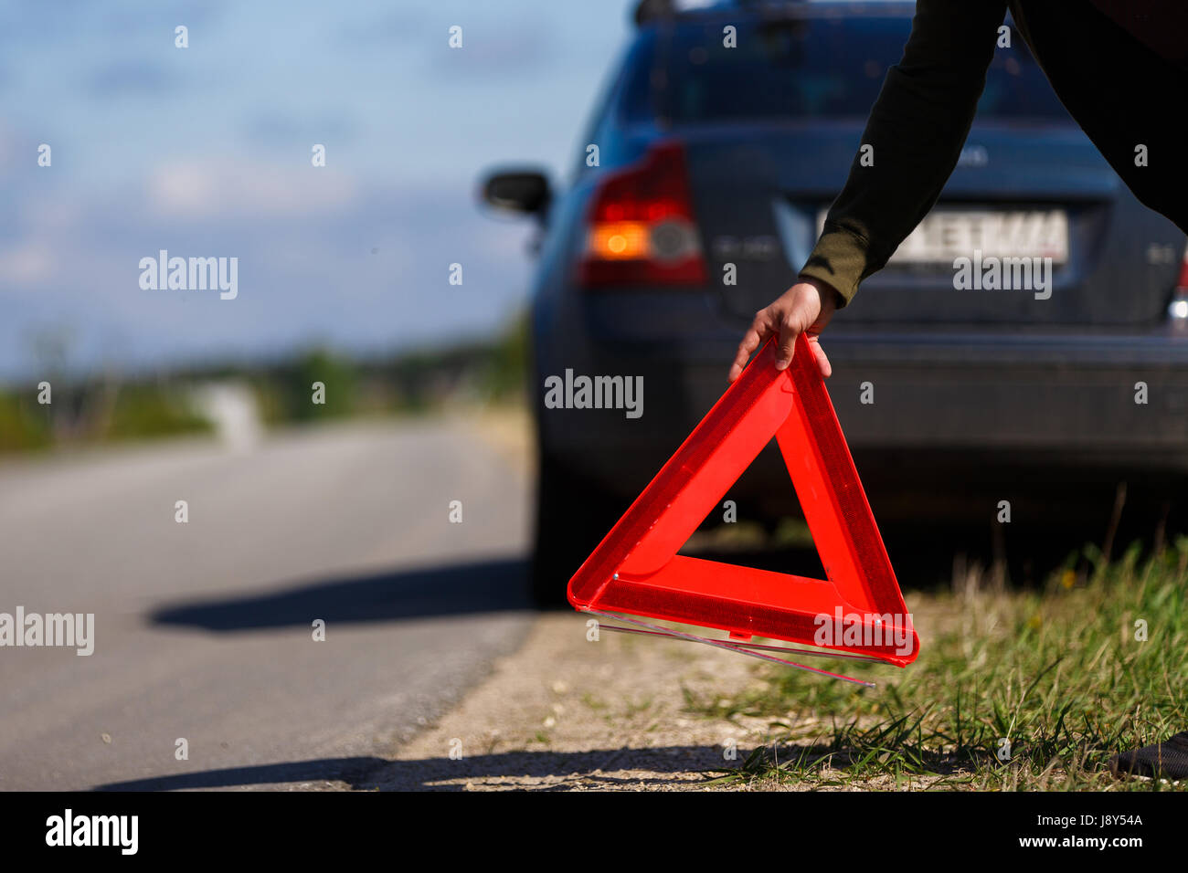 Red warning triangle in car background. Focus on road sign Stock Photo ...