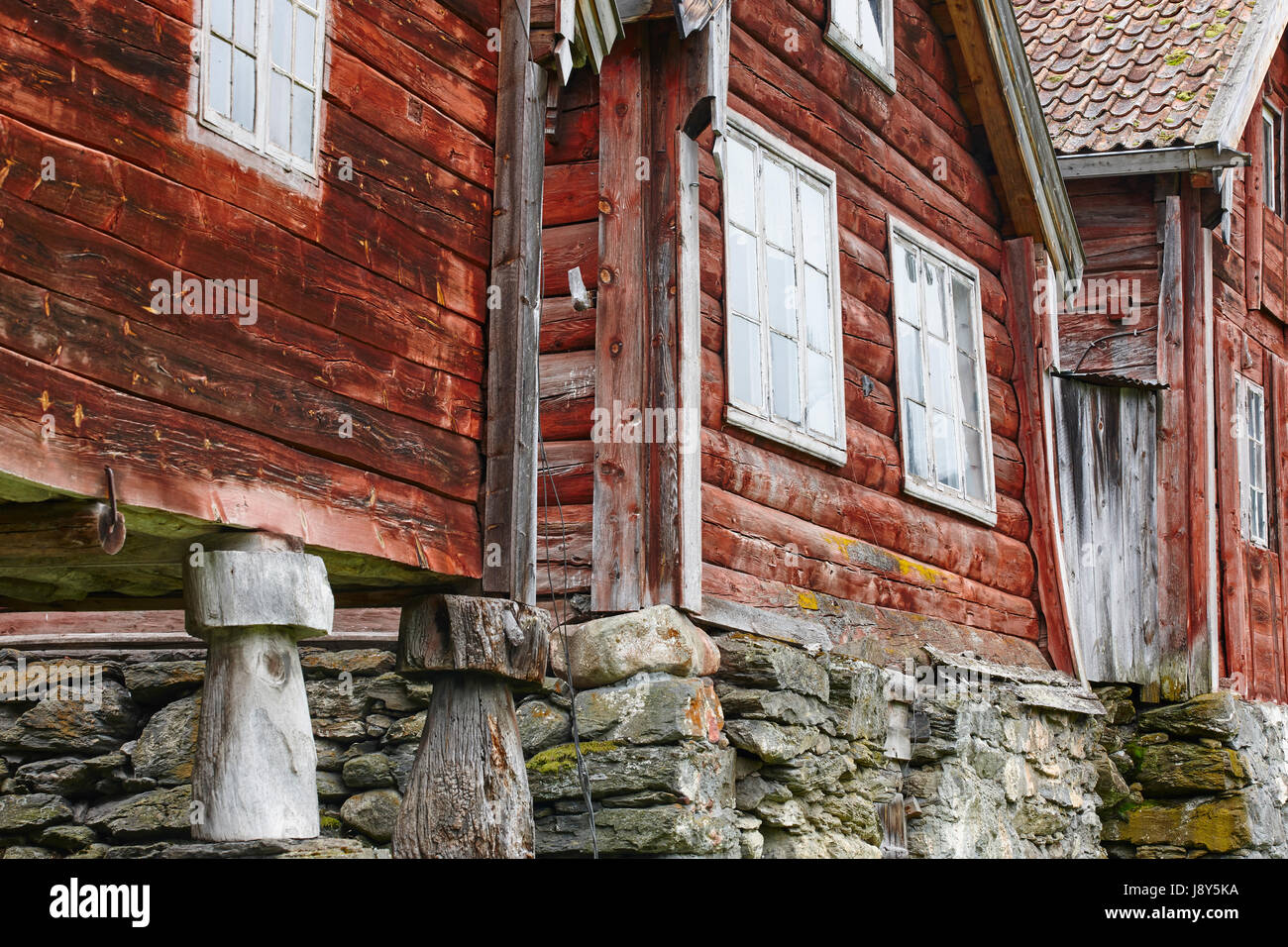 Traditional norwegian wooden red colored cabin houses facades. Otternes ...