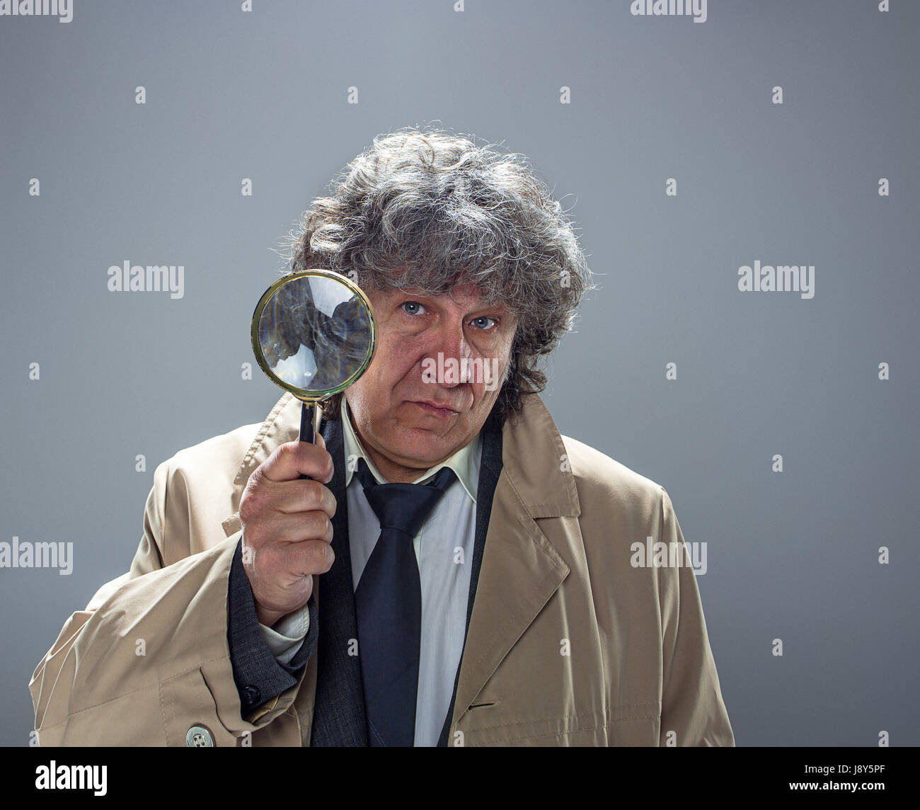 The senior man as detective or boss of mafia on gray studio background ...